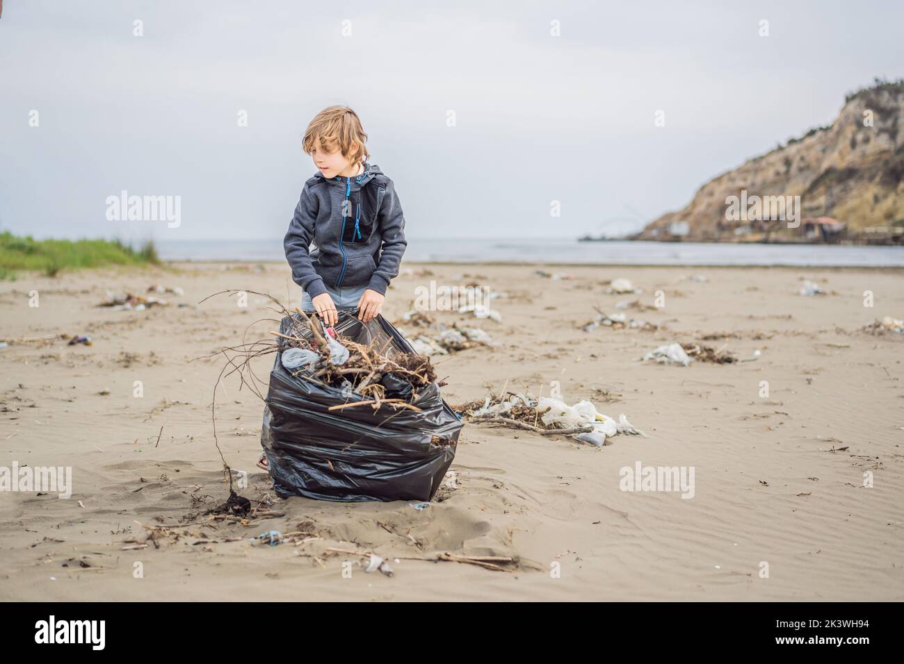 Volunteers cleaning beach from plastic. Boys walking on the beach and ... Volunteers cleaning beach from plastic. Boys walking on the beach and ...