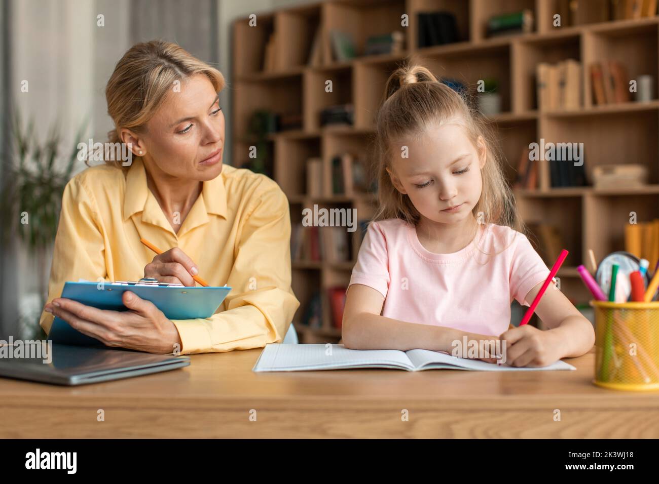 Art development concept. Talented little girl drawing with pencils ...