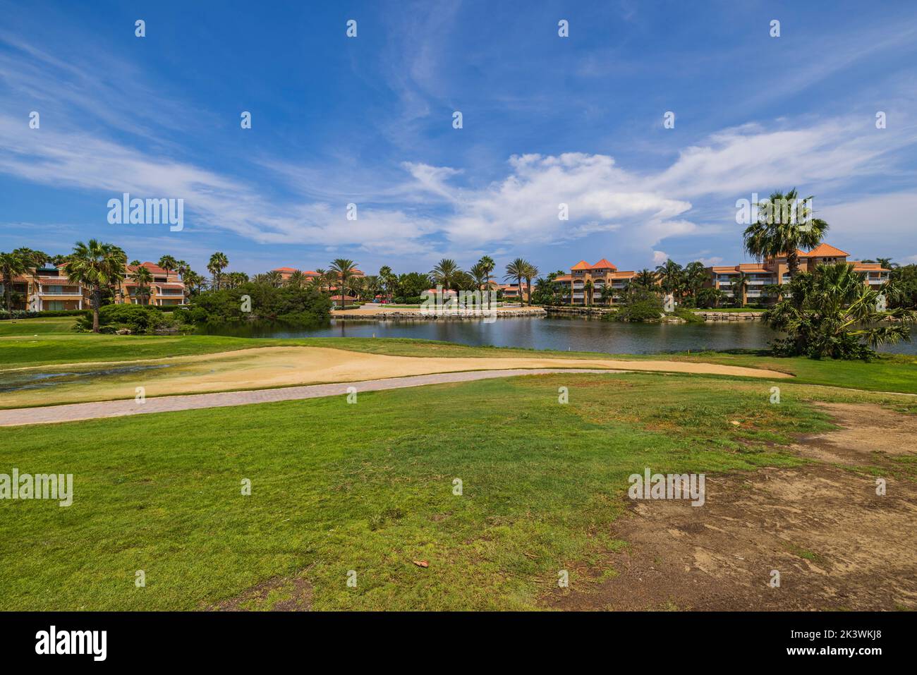 Beautiful panoramic view of hotel grounds with golf course on blue sky ...