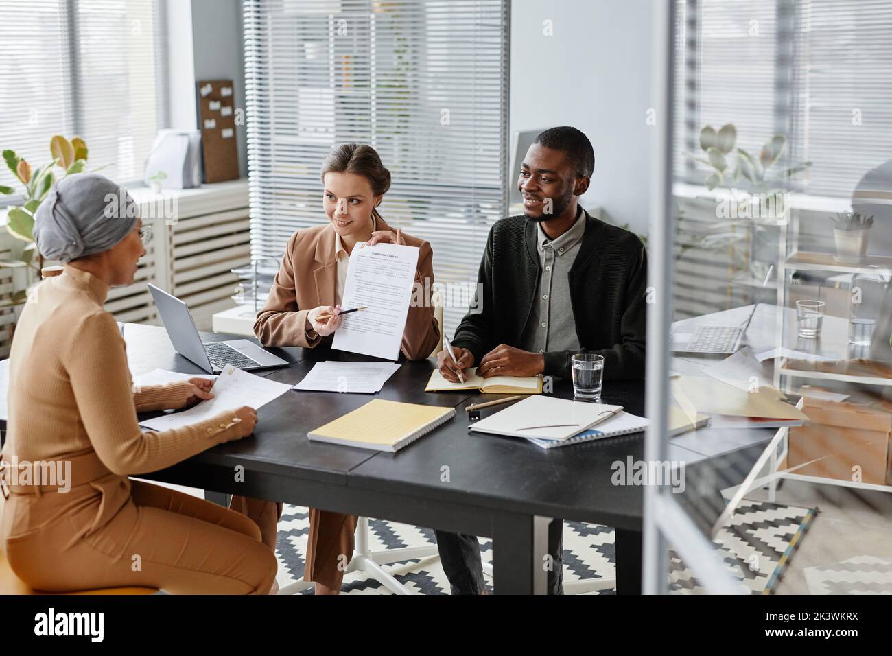 Scene of job interview in office with diverse group of people, focus on ...