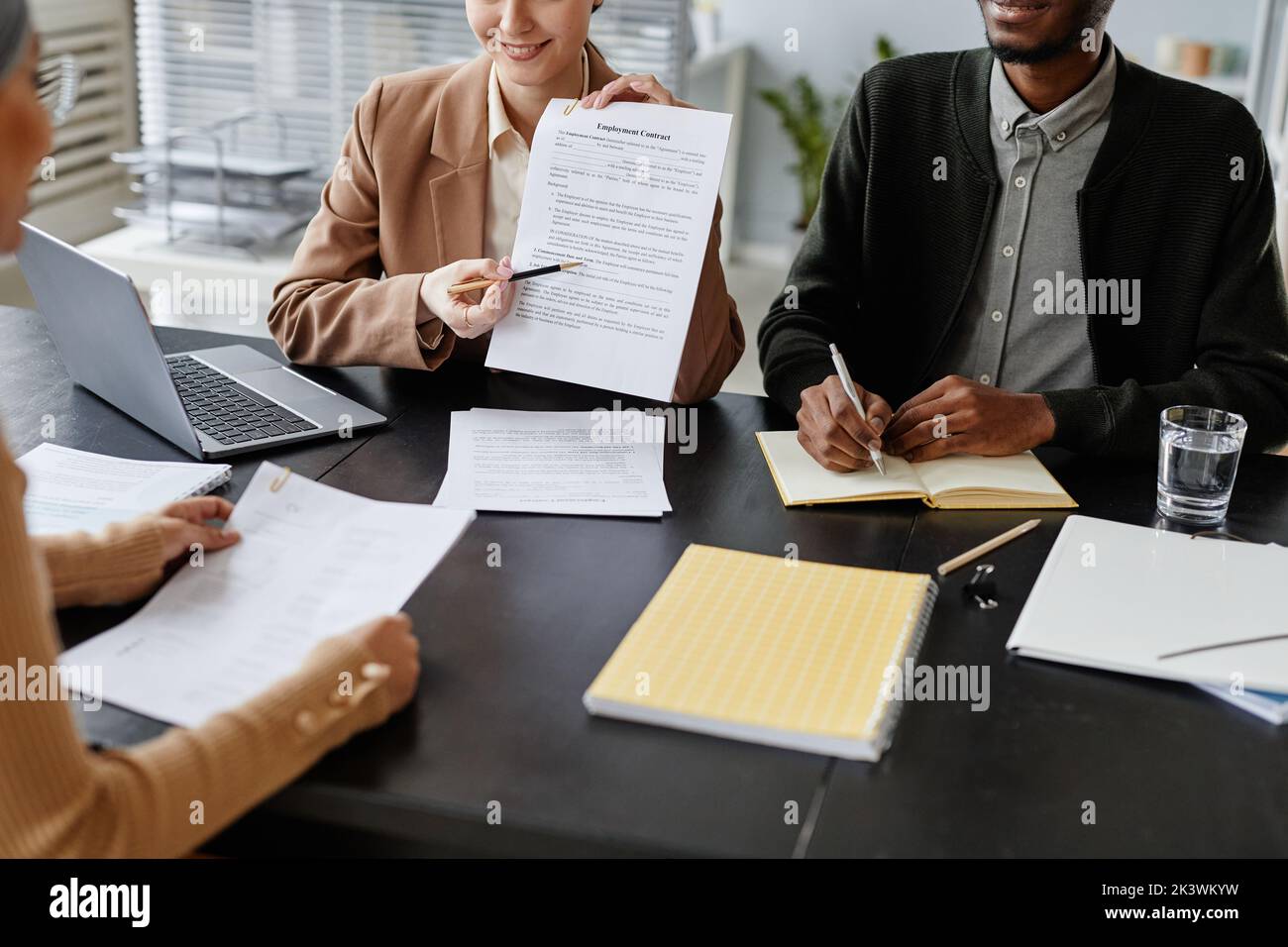 Scene of job interview in office with diverse group of people, focus on ...