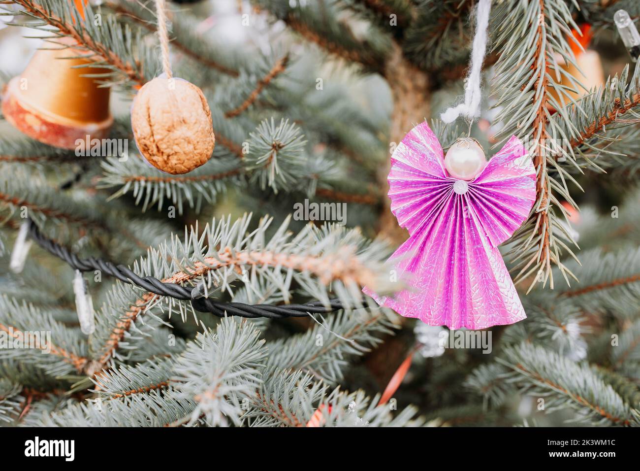 Handmade angel decoration of paper and pearl bead on Christmas tree ...