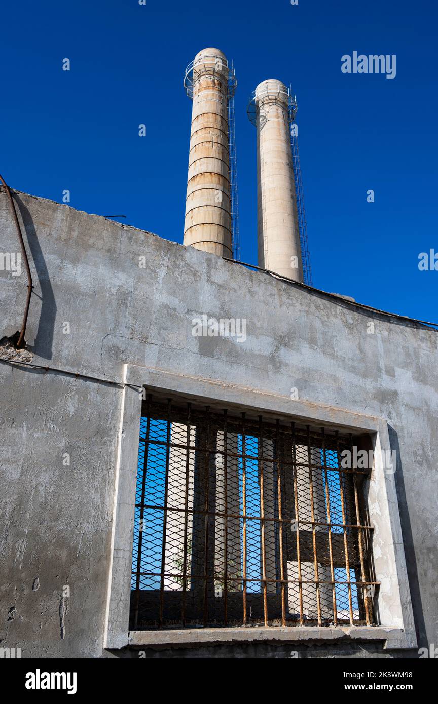 Twin chimneys remains of Cement Works demolished as seen through a ...