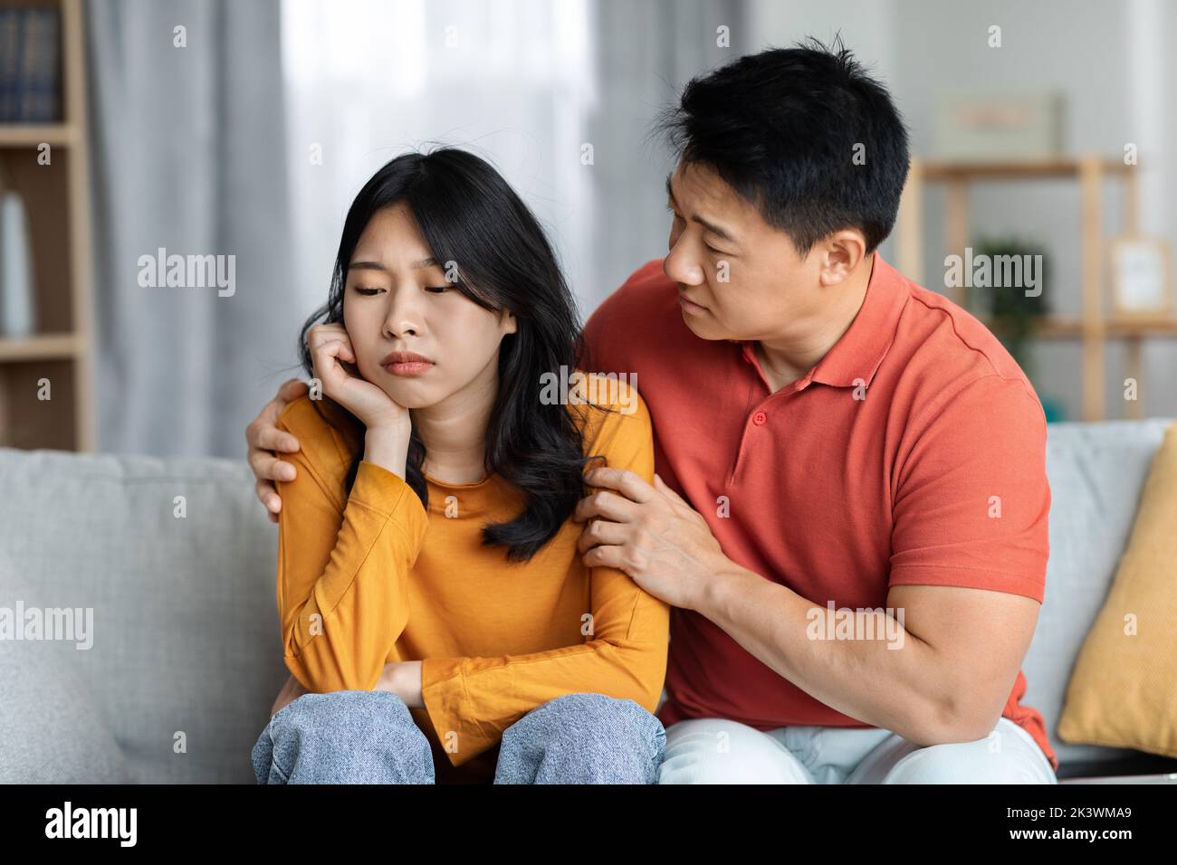 Loving asian husband comforting his upset wife Stock Photo - Alamy