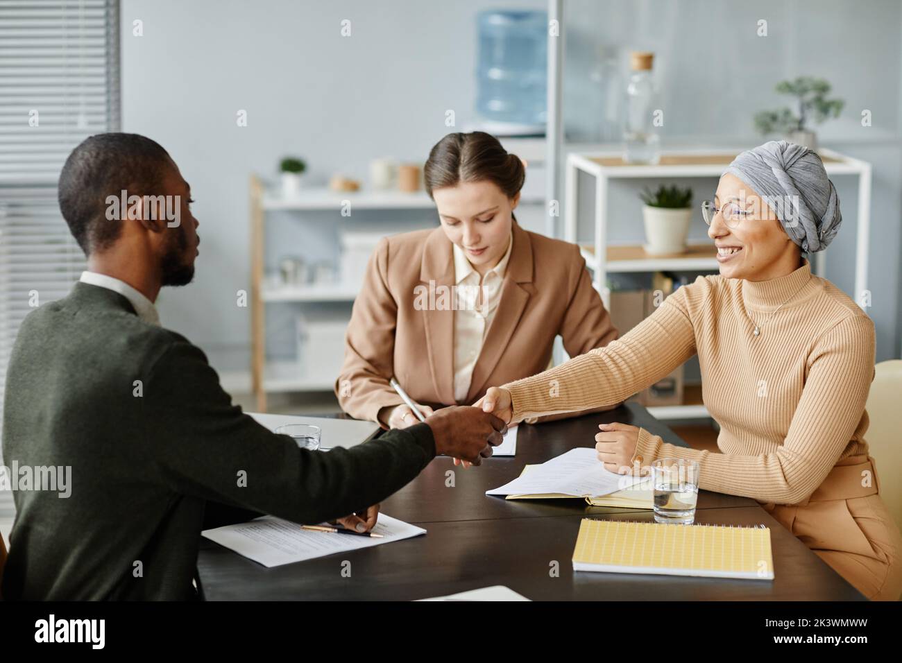 Diverse group of people in meeting or job interview at office setting ...