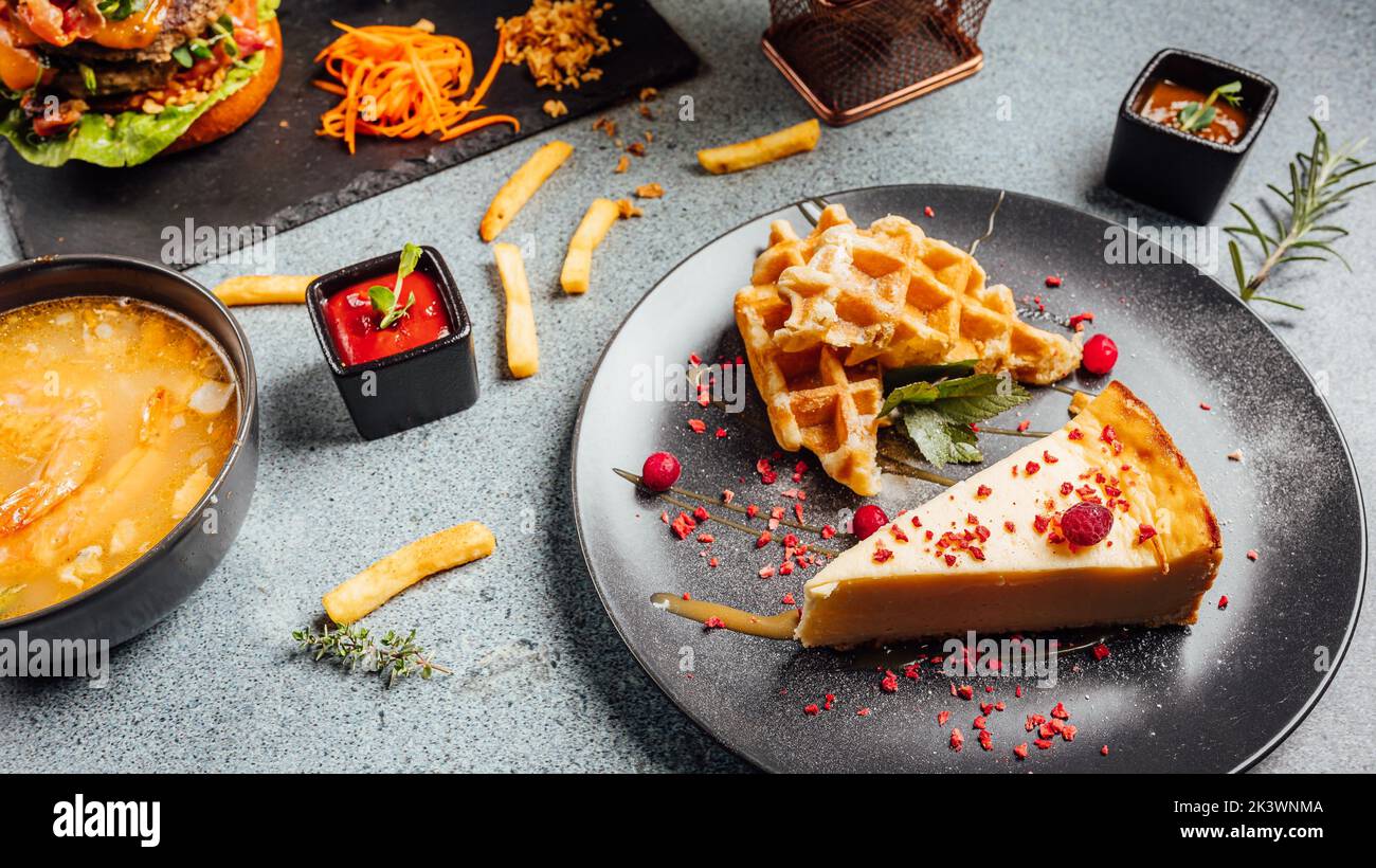A top view of a set of different dishes and a cheesecake Stock Photo ...