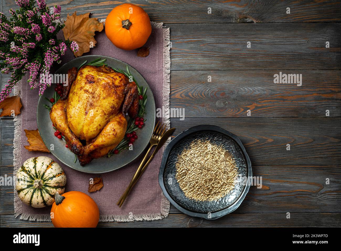 Festive table setting, roasted chicken or turkey for Thanksgiving Day ...