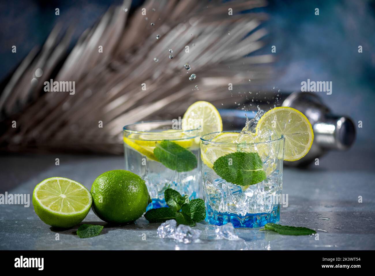 Summer alcoholic cocktail mojito or gin tonic with rum, mint, lime and ...