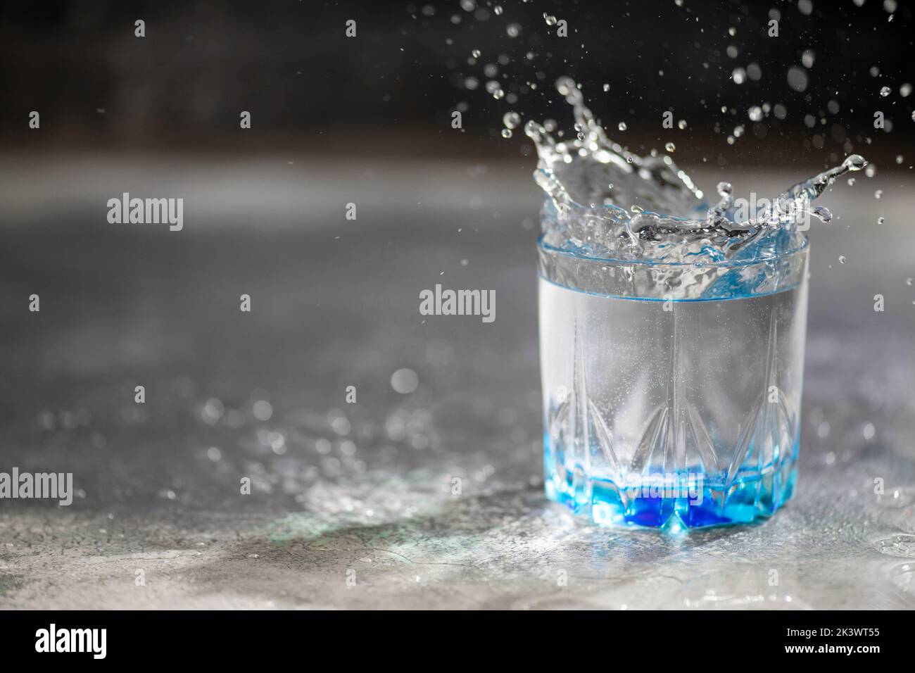 Glass of pure fresh water with splashes and drops. Splash of ...