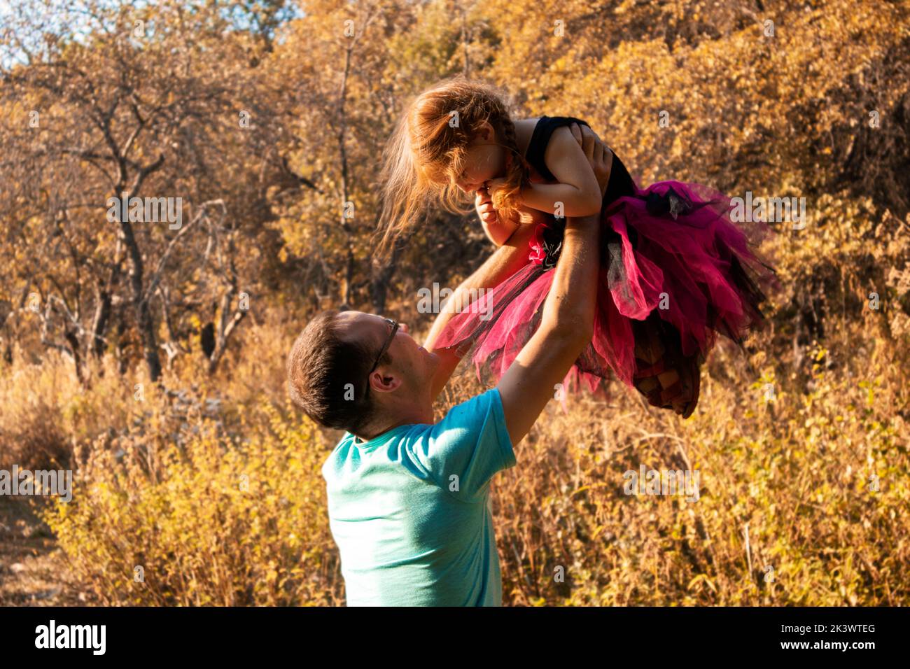 dad and daughter are dancing in nature.a little ballerina dances with ...