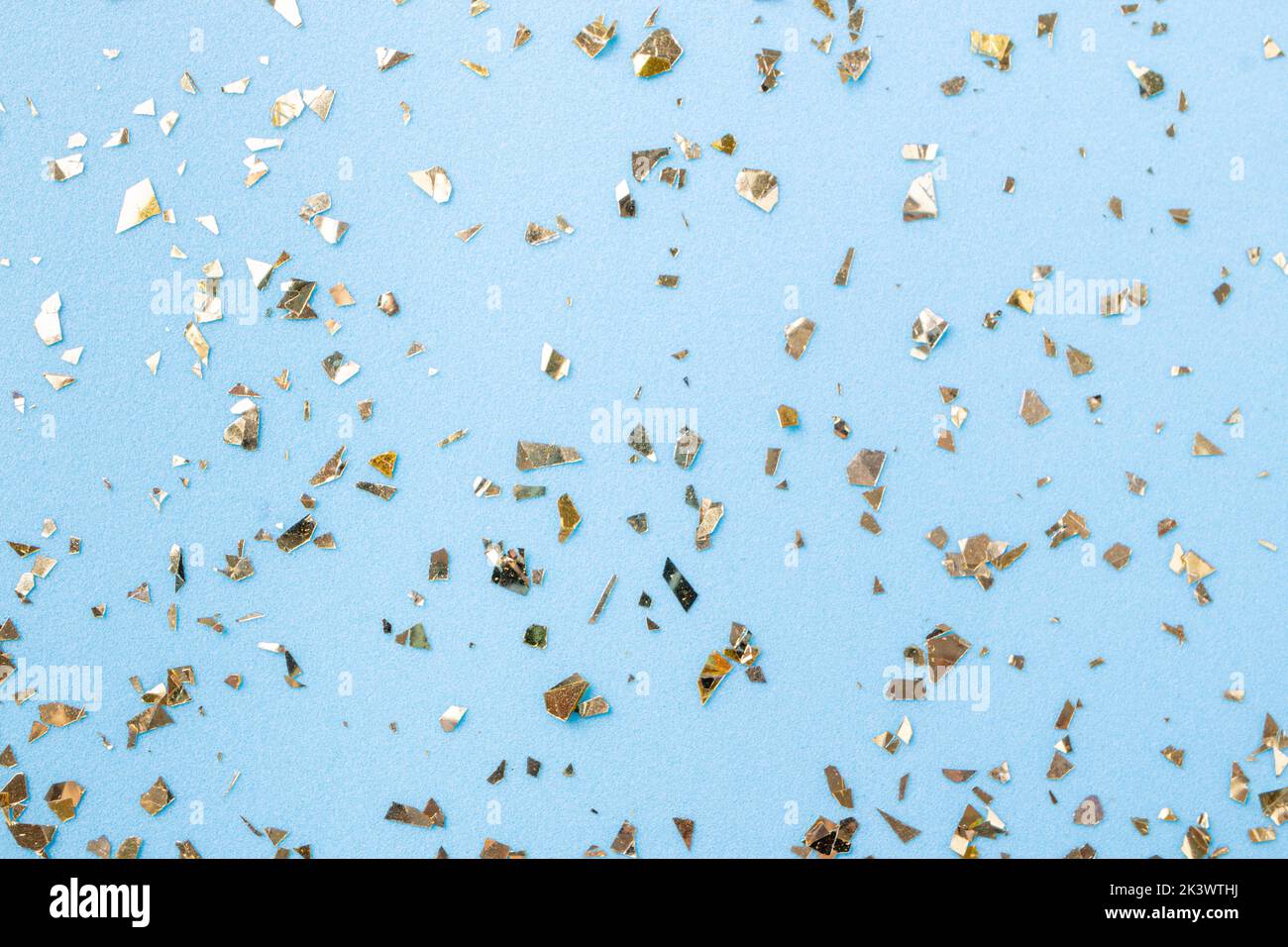 Golden flying sparkles on blue fashion holiday background. Festive ...