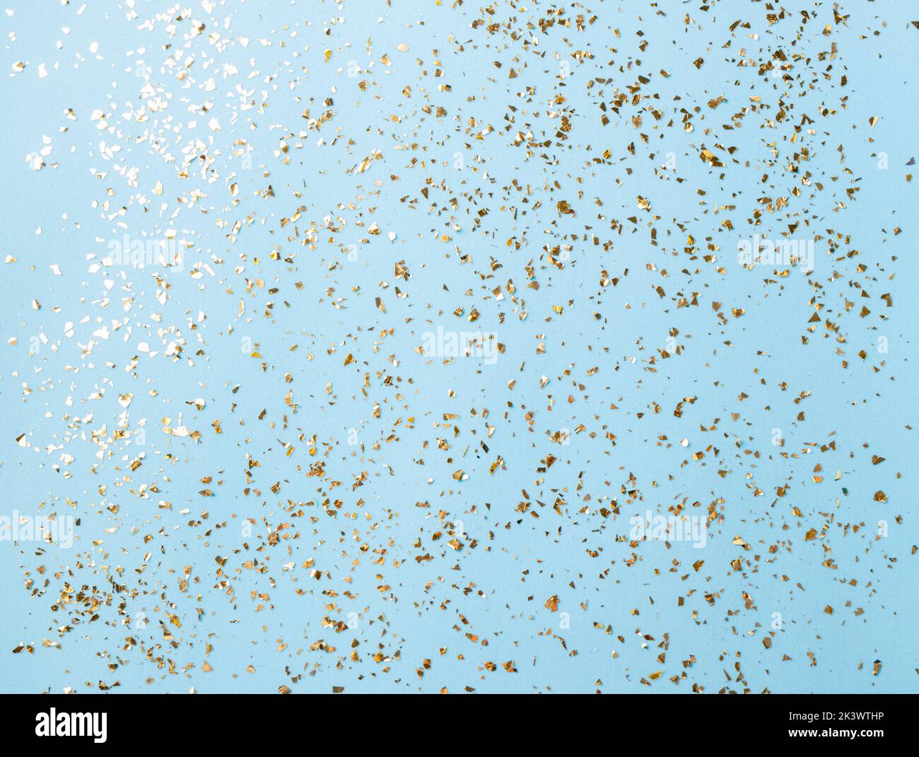 Golden flying sparkles on blue fashion holiday background. Festive ...