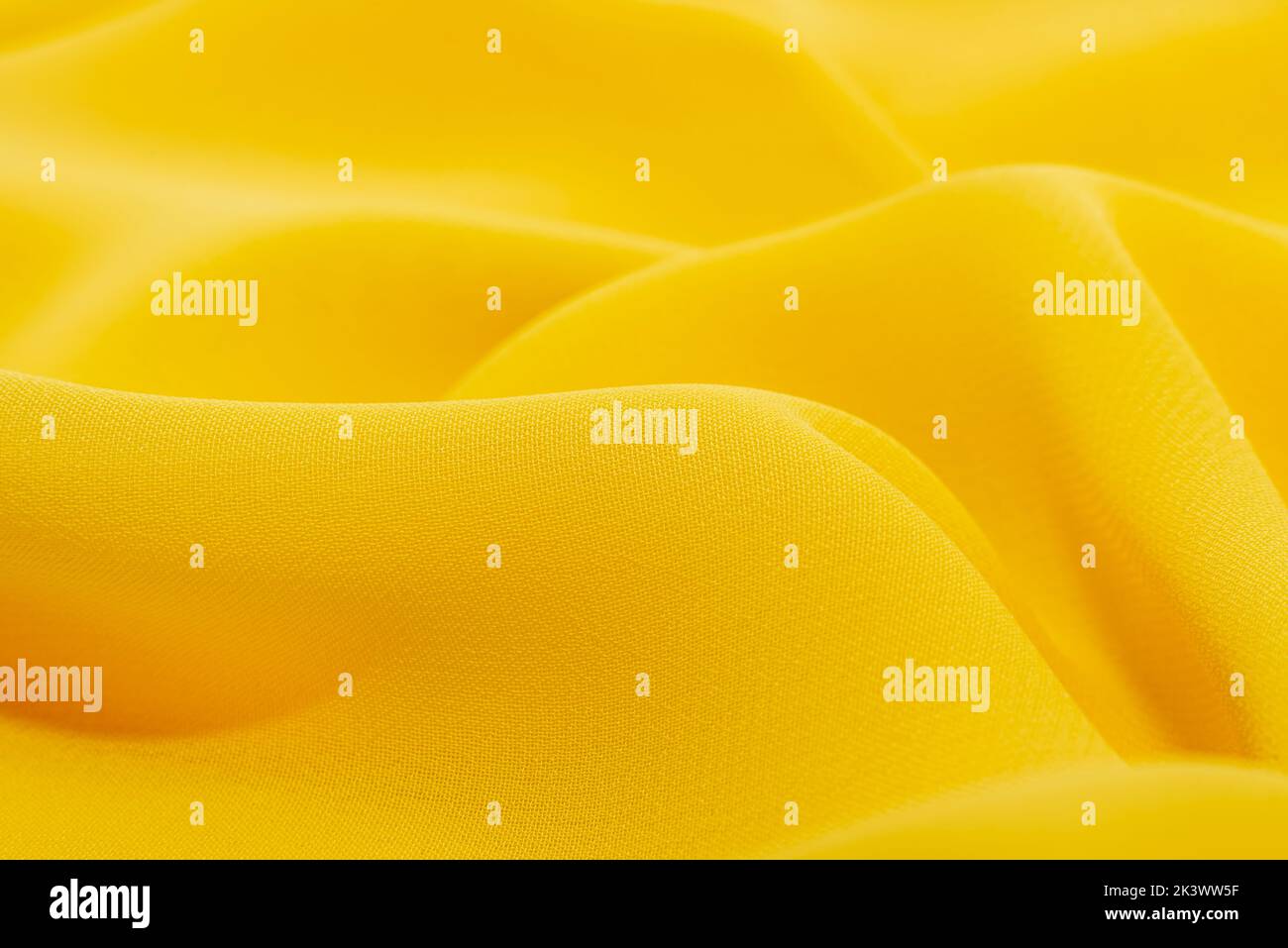 Texture of crumpled yellow fabric. Background of luxury textile or ...