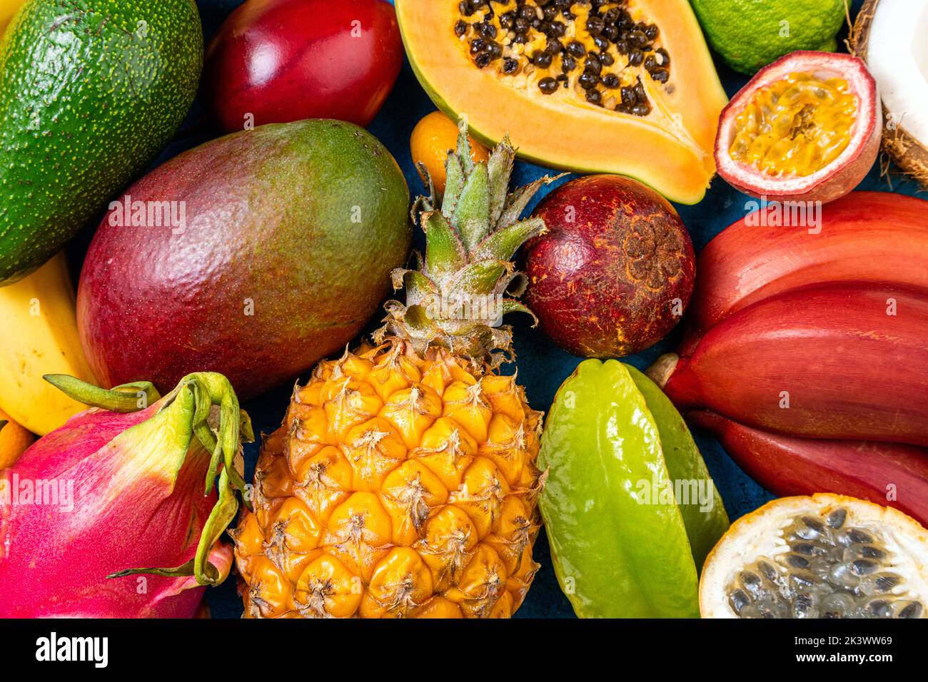 Fresh tropical fruits flat lay. Different exotic fruits on blue summer ...