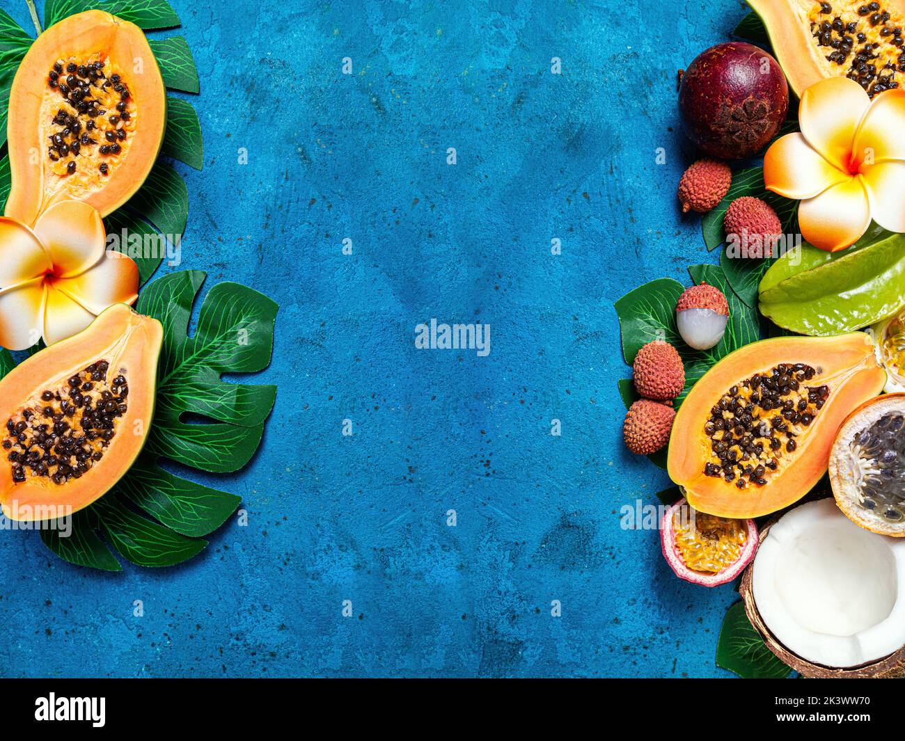 Fresh tropical fruits flat lay. Different exotic fruits on blue summer ...