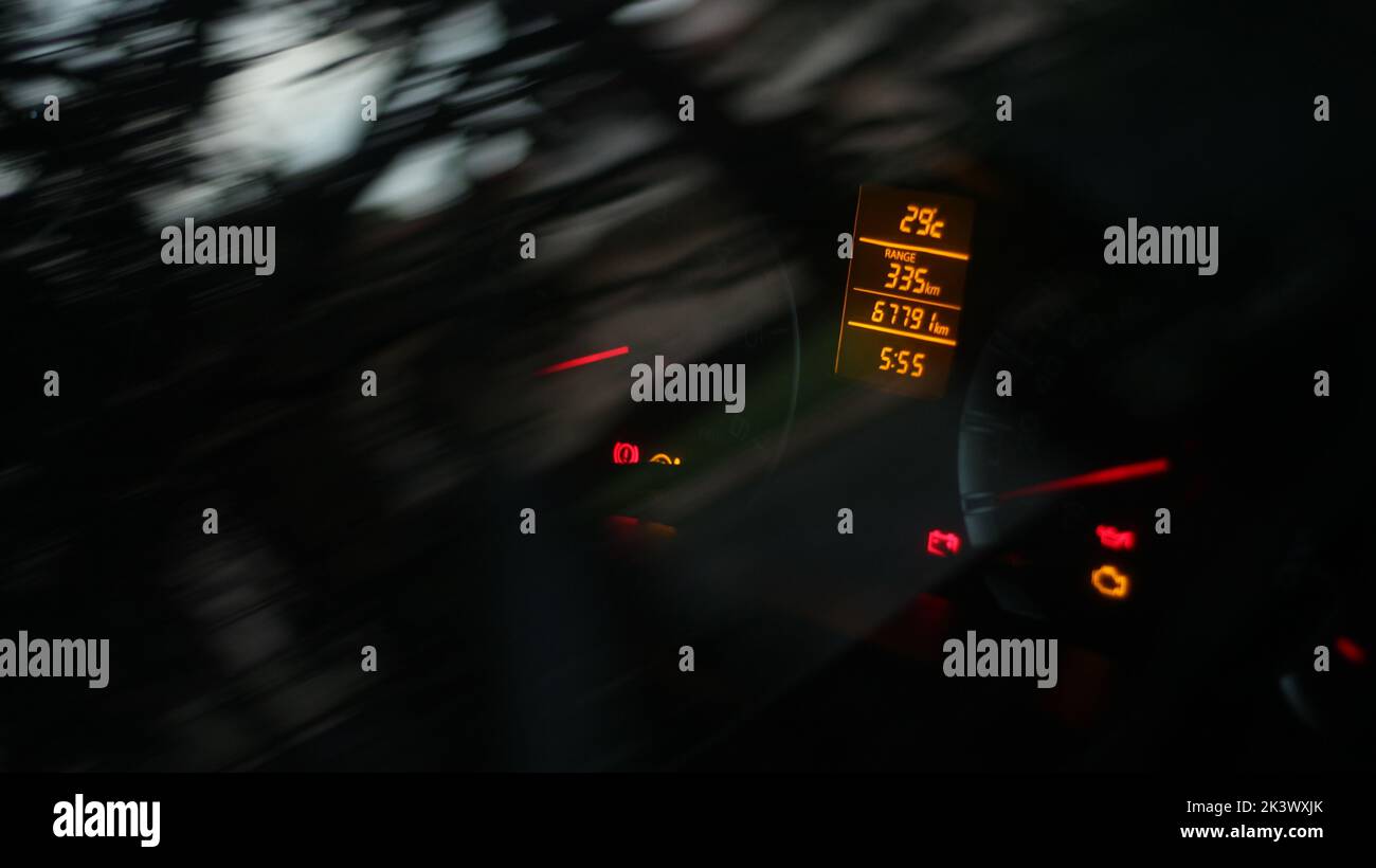 A closeup of an instrument cluster of a car behind car window Stock ...