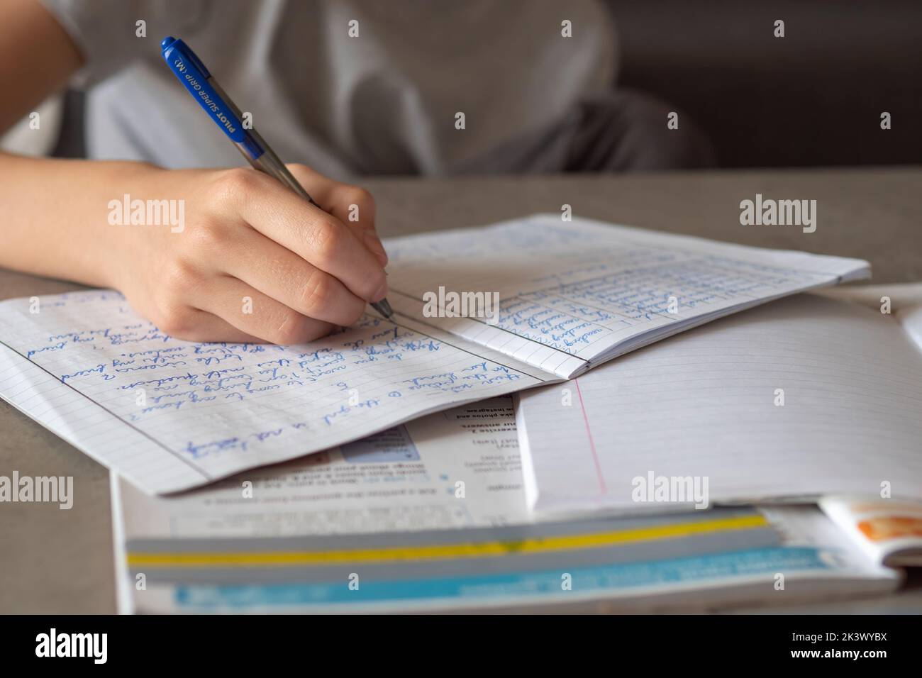 Kid affected by dyslexia doing homework, reading book using colorful ...