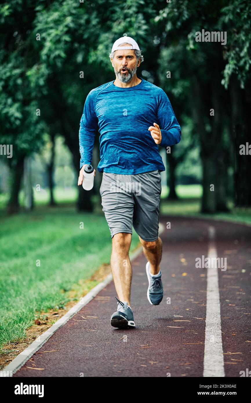 senior man running exercising sport fitness active fit Stock Photo - Alamy