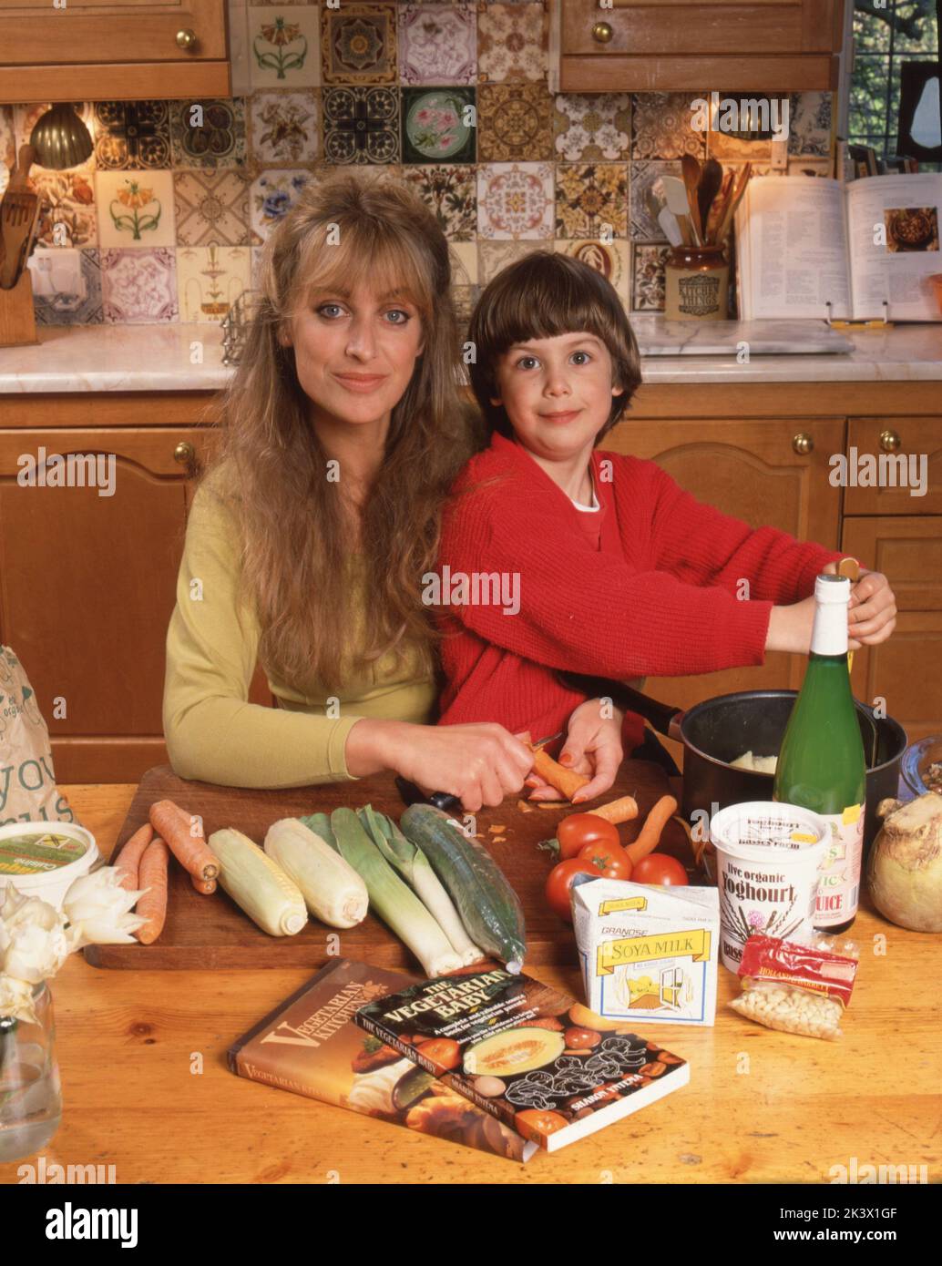 London, UK. Carol Royle and son Taran Spear at home. Circa 1990. Ref ...