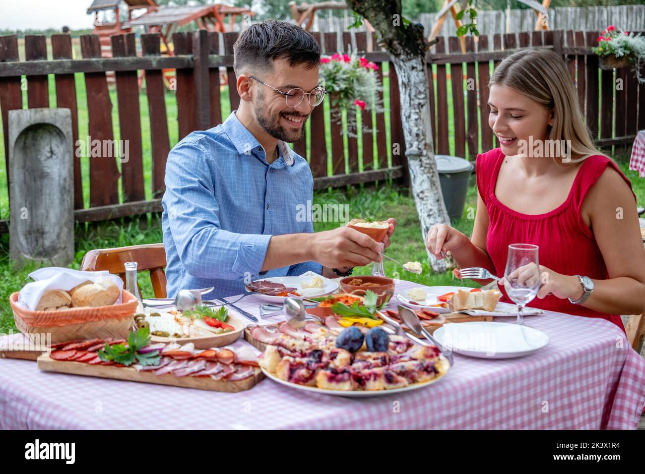 Happy young romantic couple having lunch or dinner in a beautiful open ...