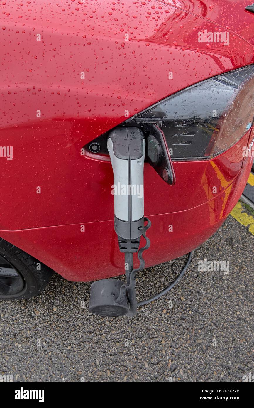 Close-up of electric vehicle charger plugged in Stock Photo - Alamy