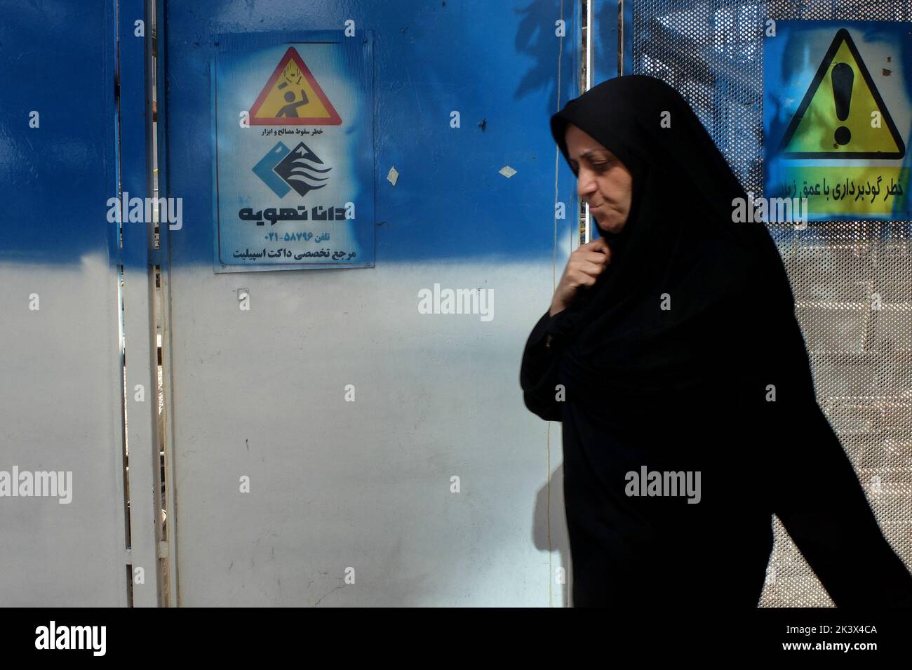 Tehran, Tehran, Iran. 28th Sep, 2022. A veiled woman walks in a street ...
