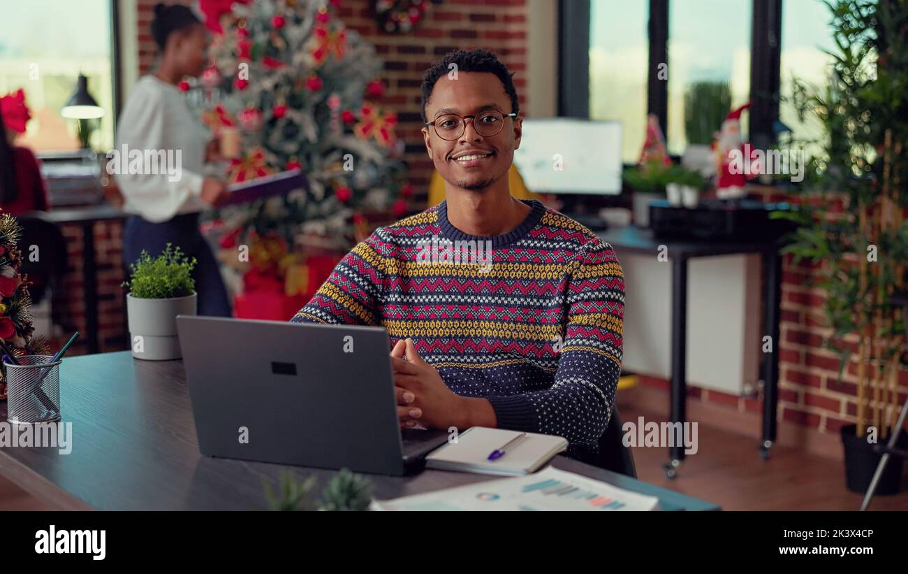 Portrait of african american man working at desk, using corporate ...