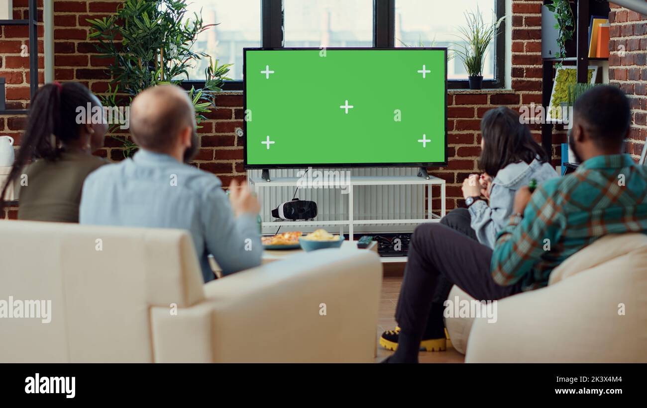 Soccer fans watching football match using greenscreen on television ...