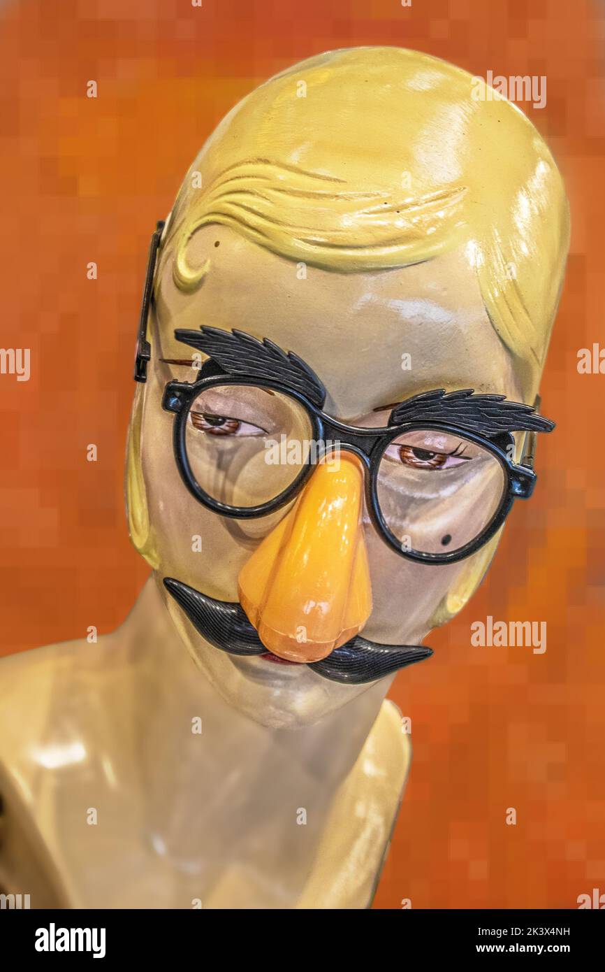 Retro mannequin head with forehead curl wearing funny costume glasses ...