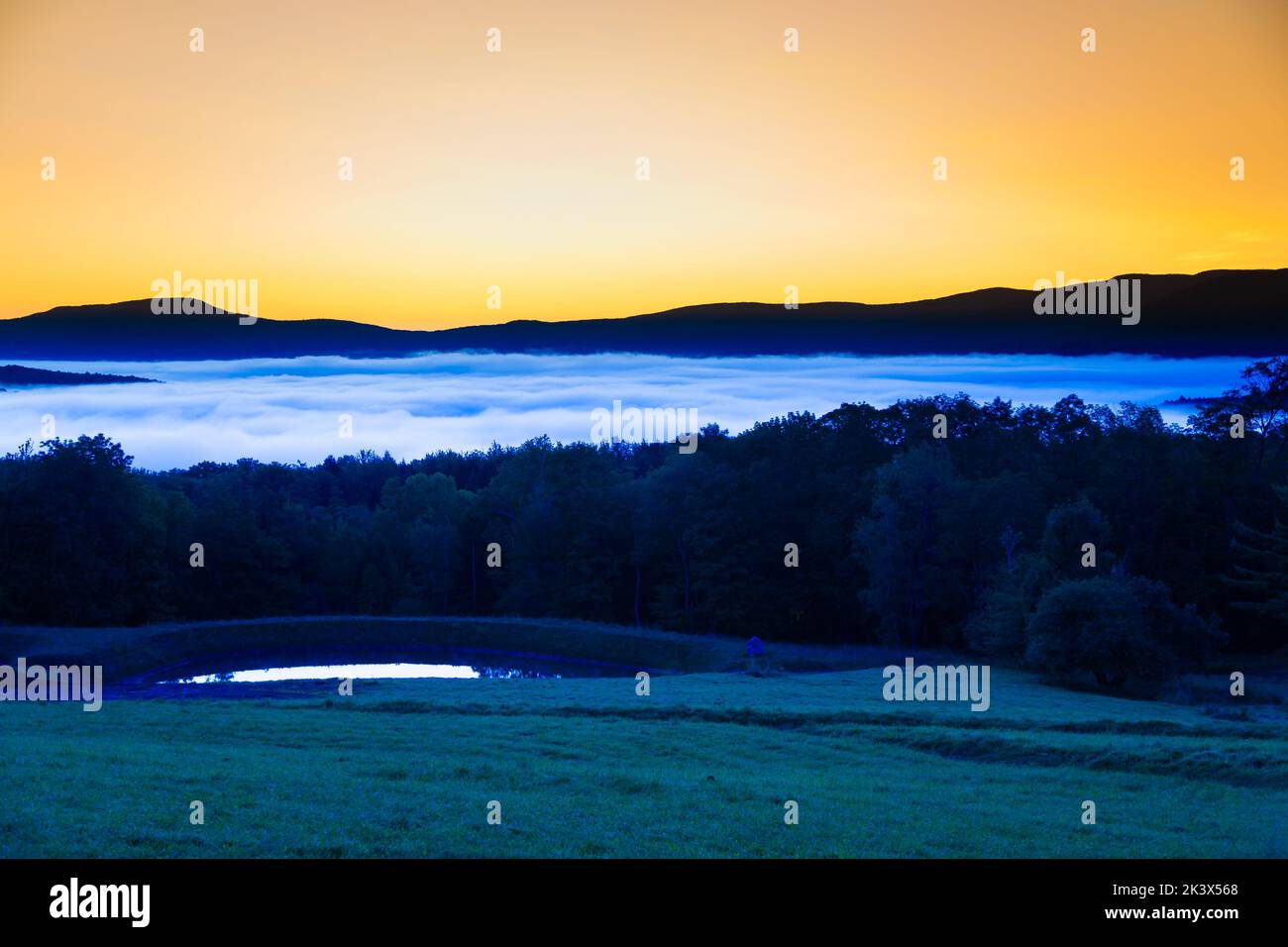 Early morning sunrise of a fog enshrouded valley in the New England ...