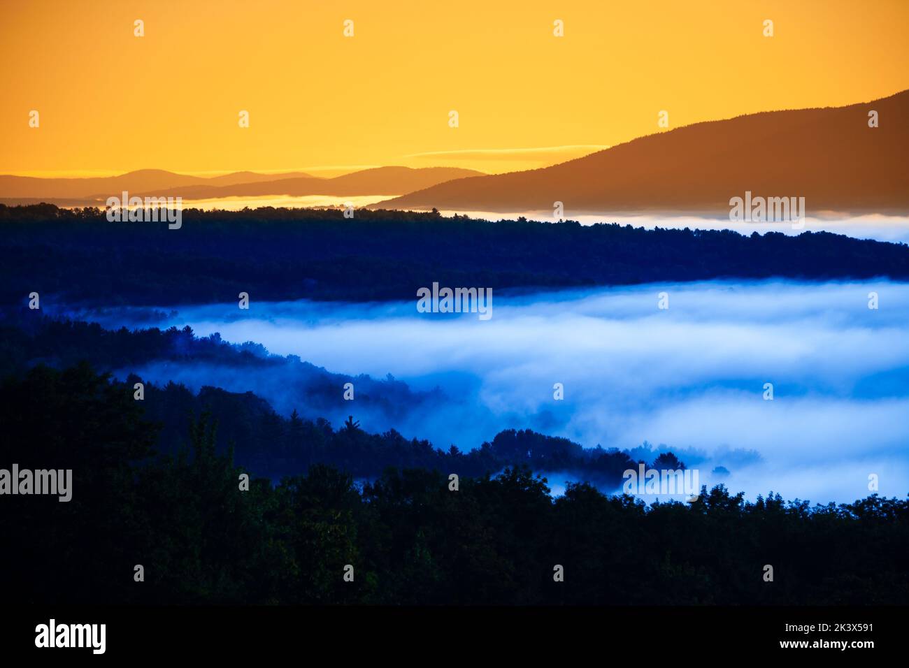 Early morning sunrise of a fog enshrouded valley in the New England ...