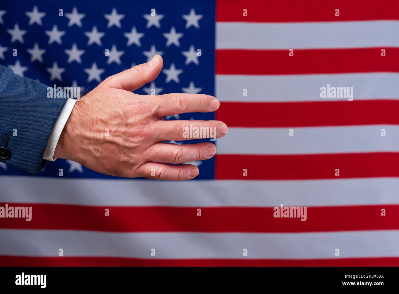 Open hand waiting to be shaken with the United States flag in the ...