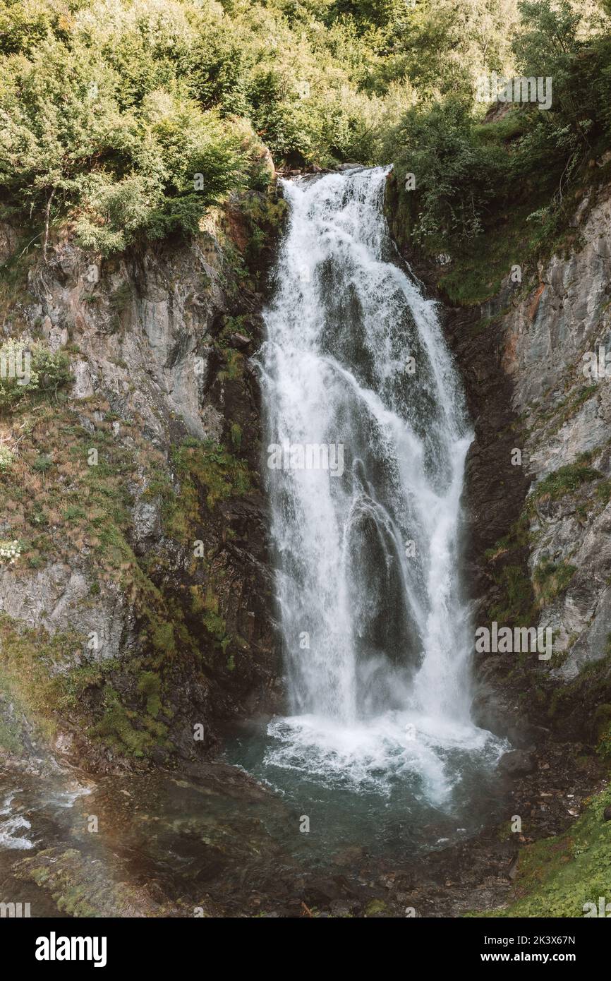 A beautiful landscape of a waterfall streaming from the middle of a ...