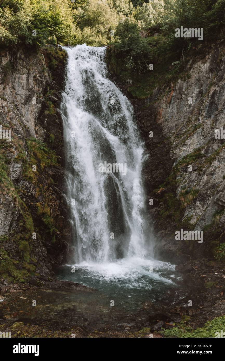 A beautiful landscape of a waterfall streaming from the middle of a ...
