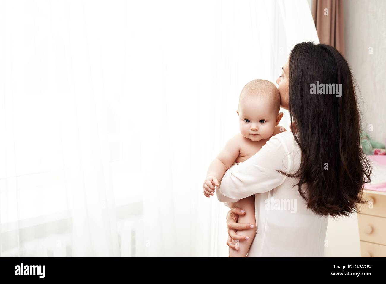 Happy mother holding and hugging adorable newborn baby Stock Photo - Alamy