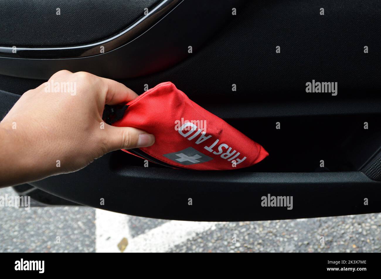 A first aid kit, in the storage of a car door. Useful in case of ...