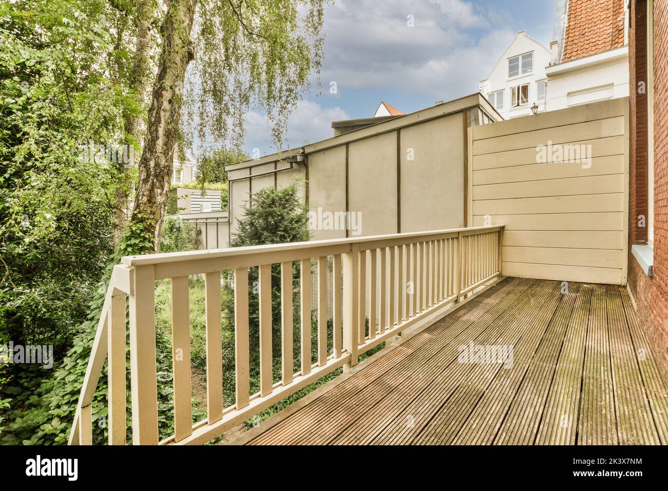 Front view of brick buildings and cars with bicycles from small balcony ...