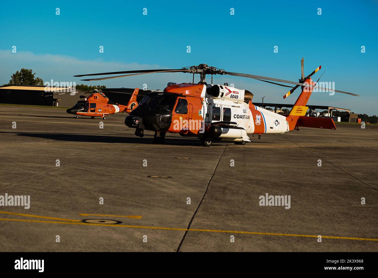 A Coast Guard MH-60 Jayhawk and MH-65 Dolphin helicopter are staged on ...