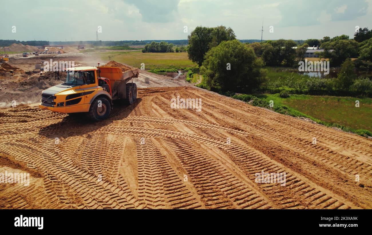 A dumper truck loaded with earth, transporting it. Heavy construction ...