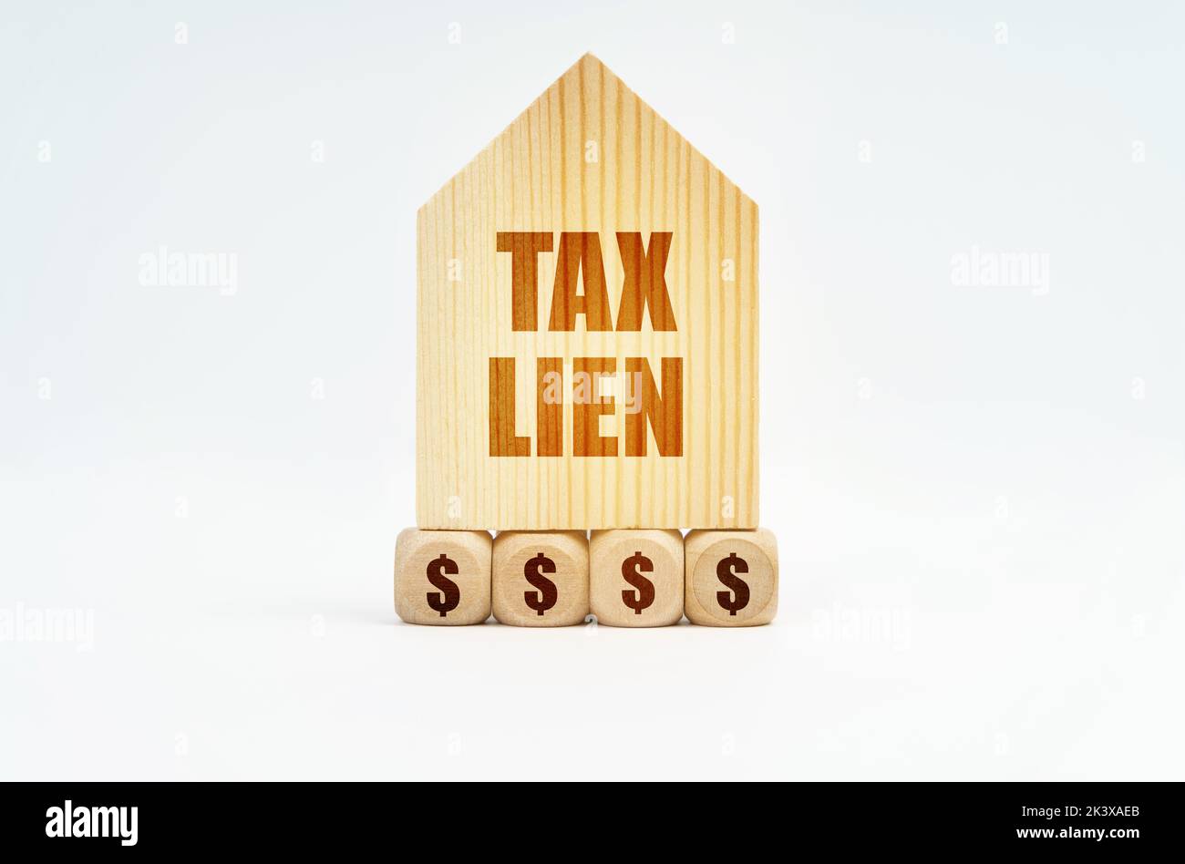 Real estate and business. On a white surface stands a wooden model of a ...