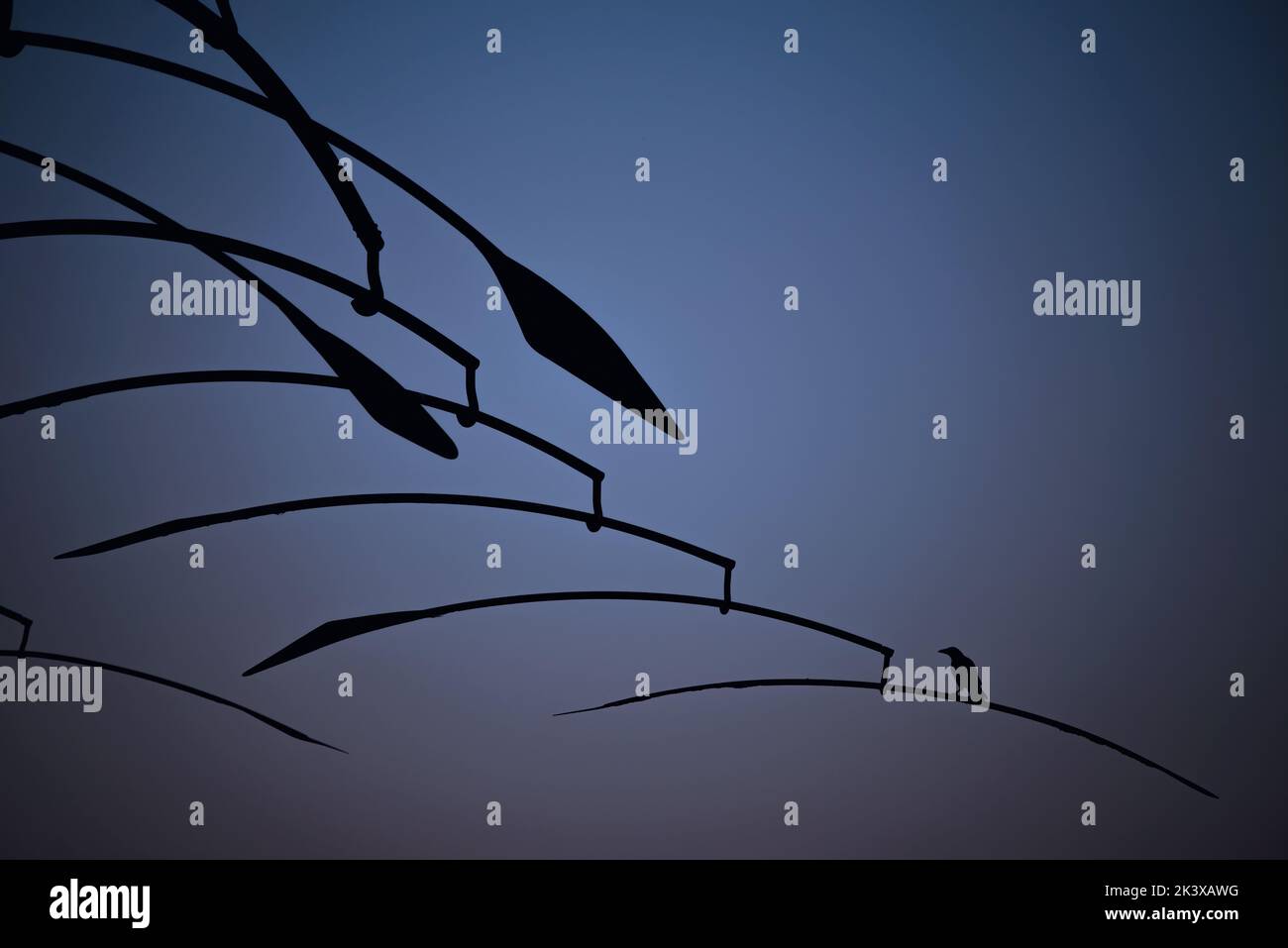 Silhouette of a crow on an artistic statue Stock Photo - Alamy