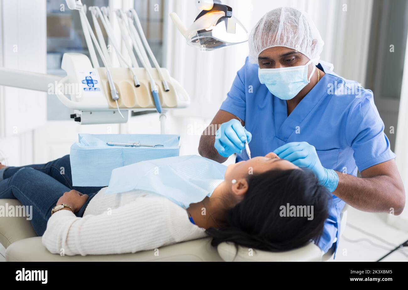 Male dentist performing teeth examination hi-res stock photography and ...