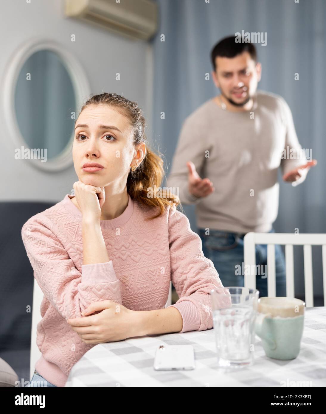Offended woman sitting at home after spat with boyfriend Stock Photo ...