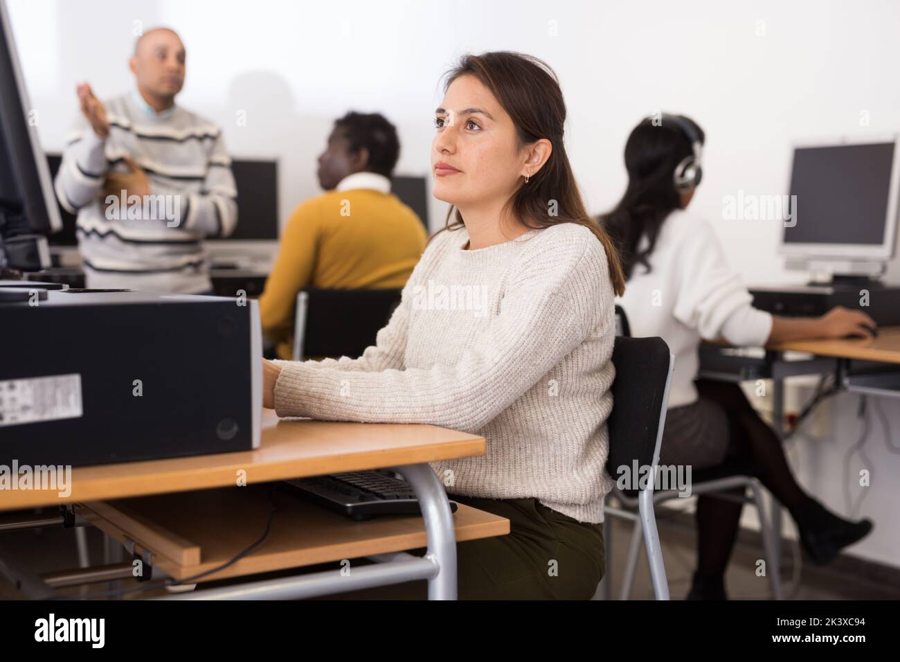 Young Latina working with computer in public library Stock Photo - Alamy