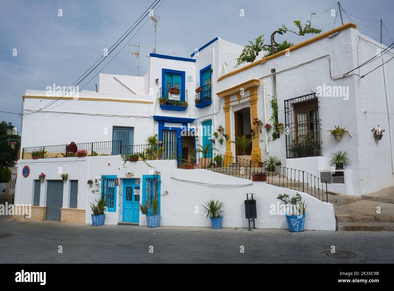 The exterior design of a beautiful white building with blue windows and ...