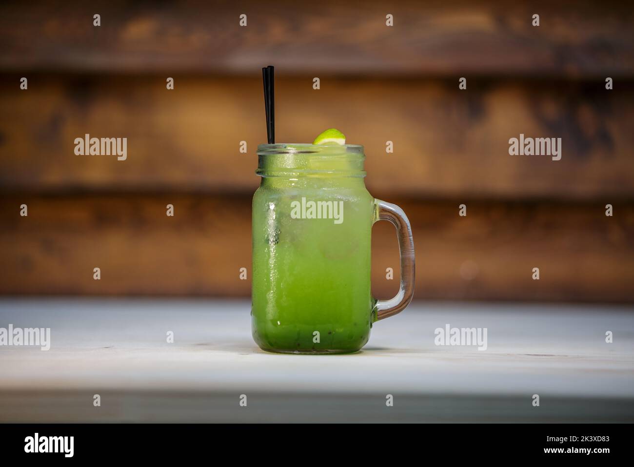 A Shallow focus of a Mint lemonade cocktail and lemon on a wooden ...