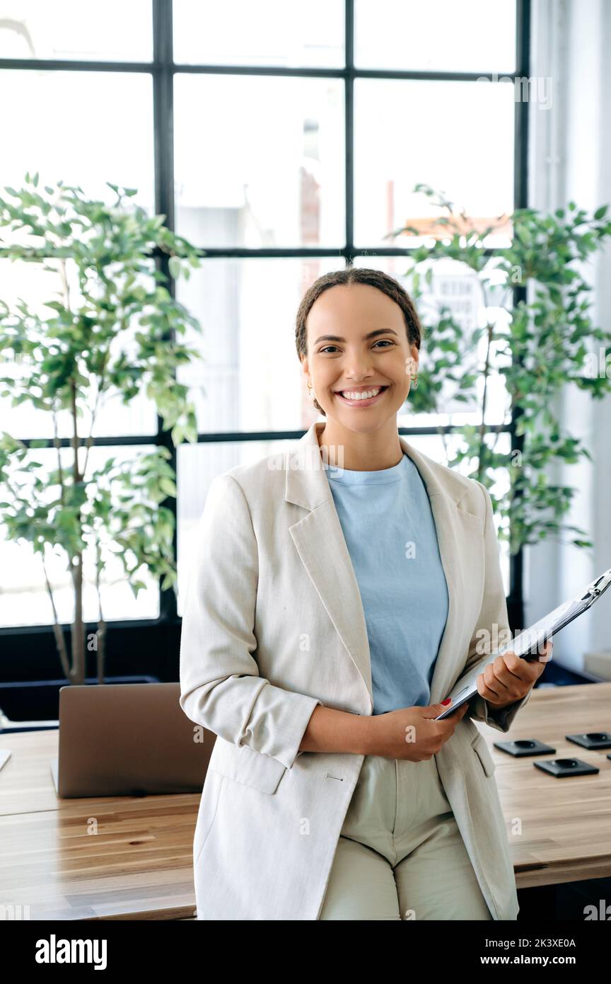 Portrait of beautiful contented mixed race woman, business lady, broker ...