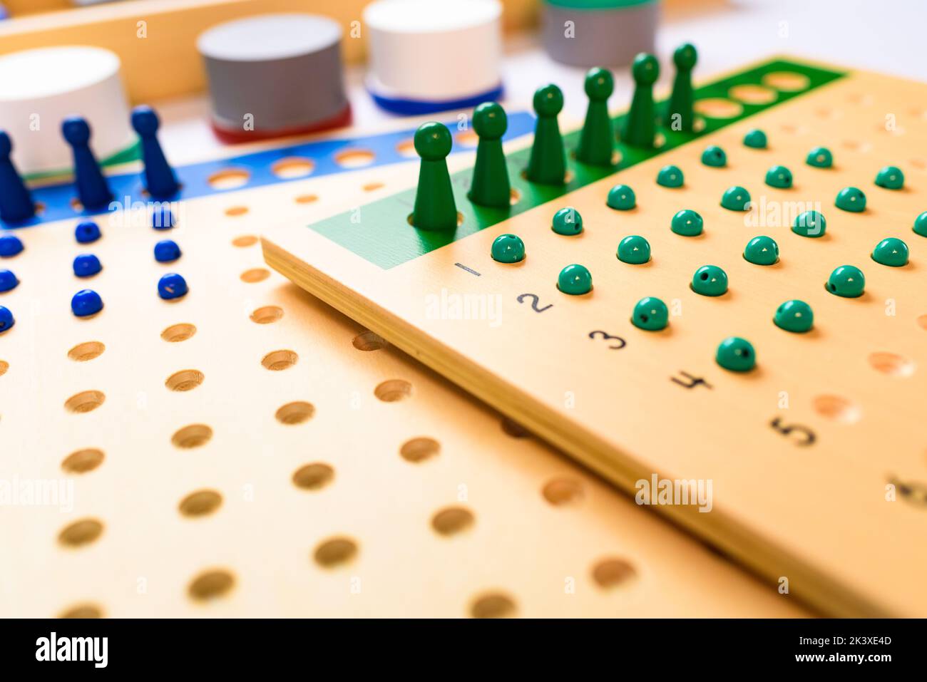 Detail of pins and beans on a montessori board to perform mathematical ...