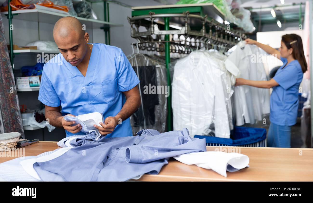 Worker checking clean clothes hi-res stock photography and images - Alamy