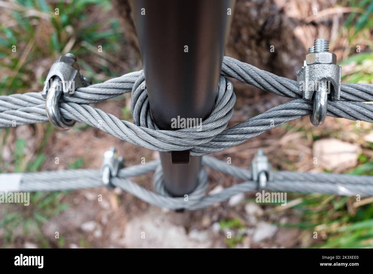 Interlocking steel cable secures a barrier on a mountain path Stock ...